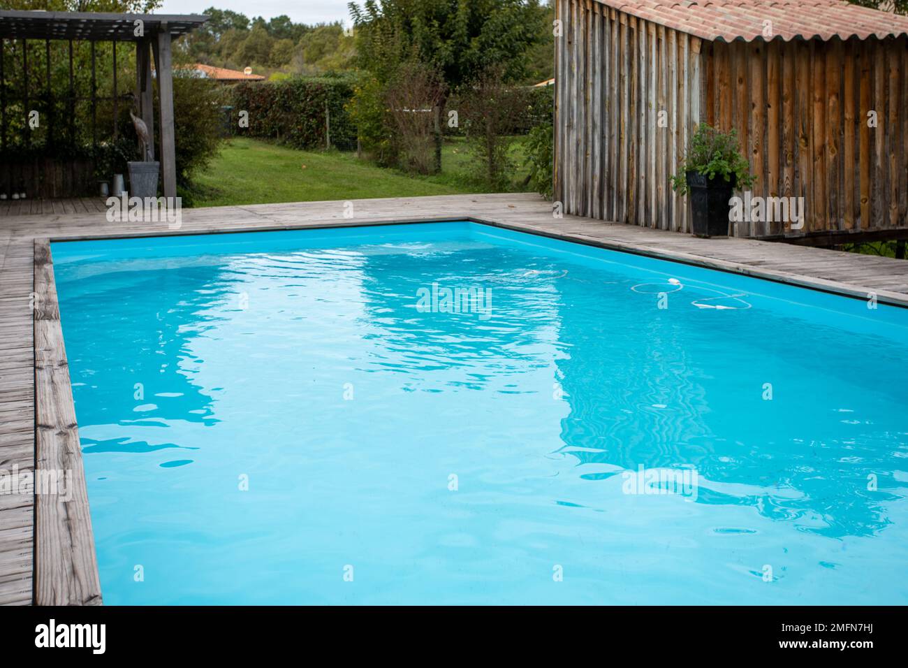 private family home swimming pool with wooden terrace blue transparent ...
