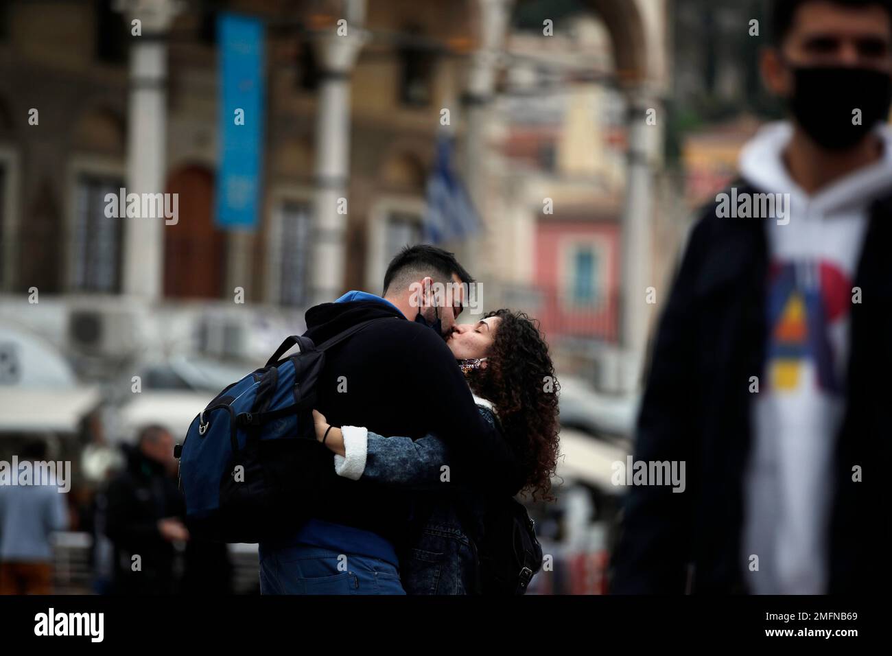 A couple kiss each other in Athens, Friday, Nov. 6, 2020. With a surge ...