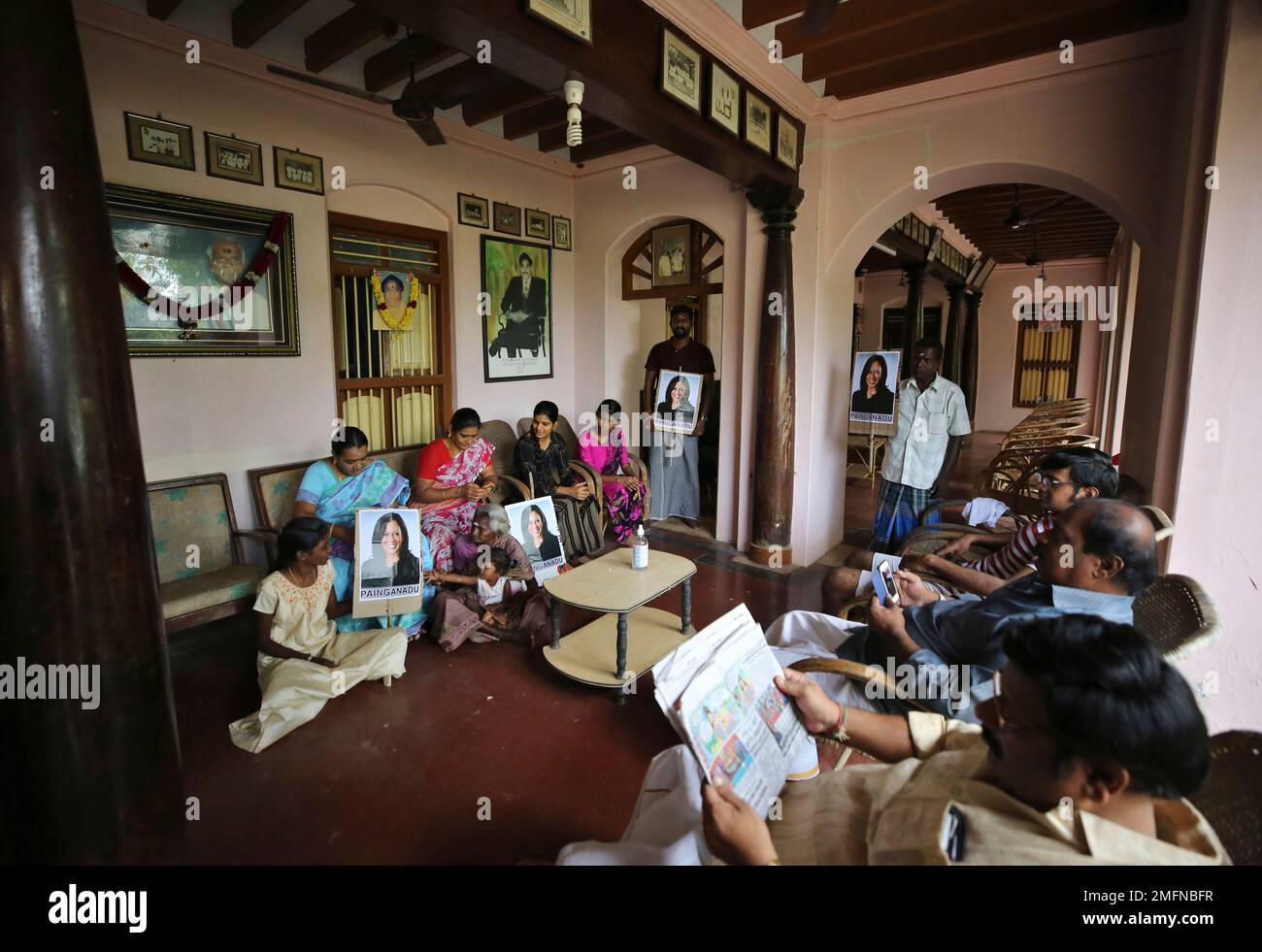 Members of the Vandayar family sit in the living area of their ...