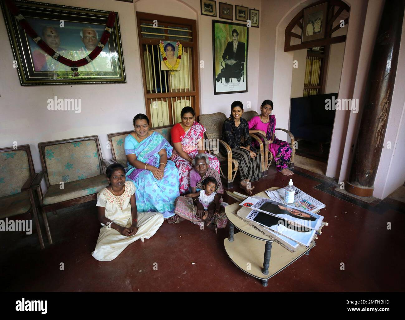 Members of the Vandayar family sit in the living area of their ...