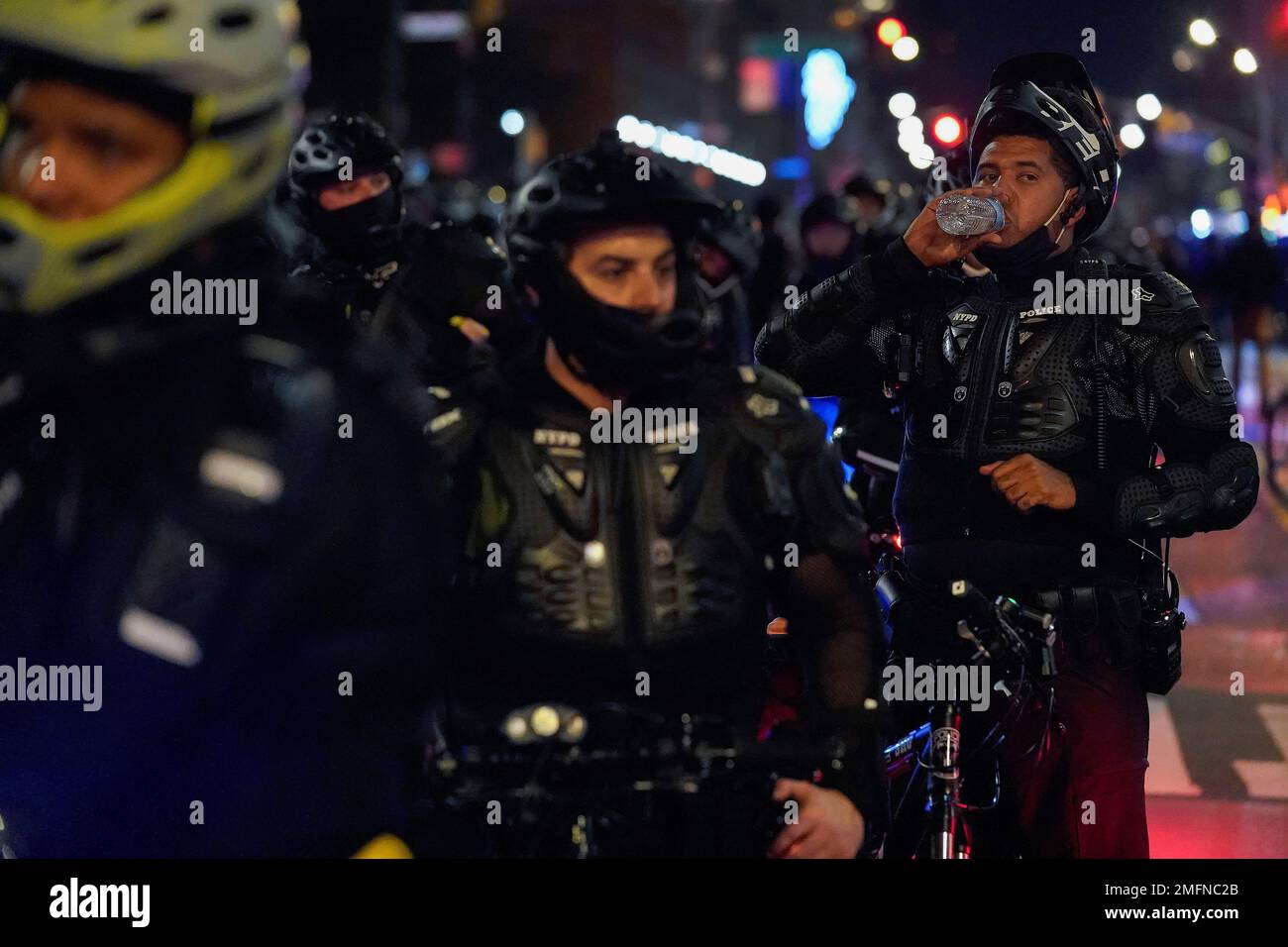 NYPD bike patrol officers take a break after making arrests during a ...