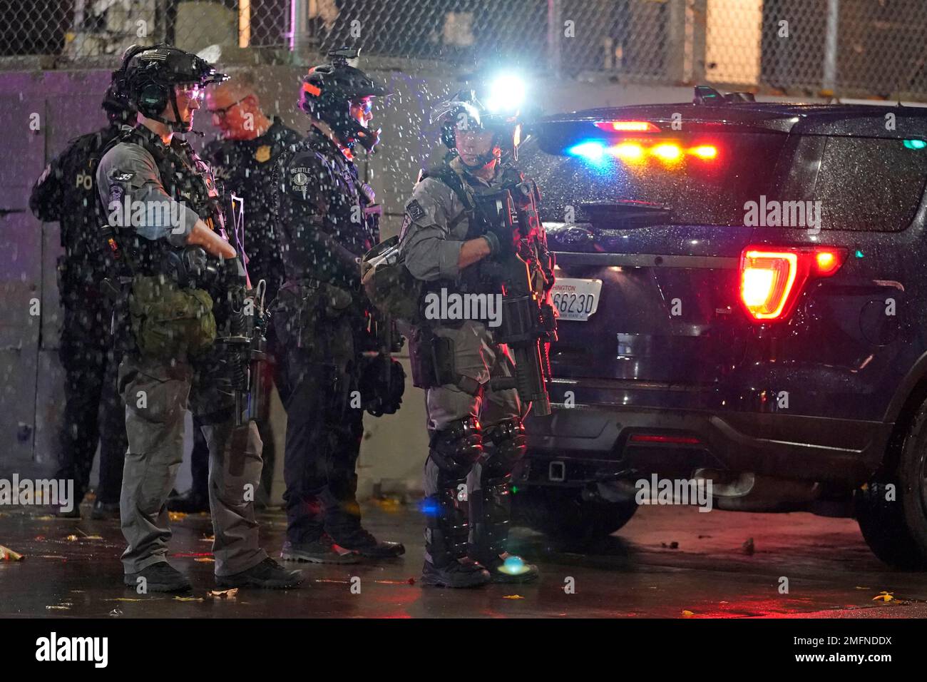 Seattle Police officers stand by with crowd-control and other weapons ...