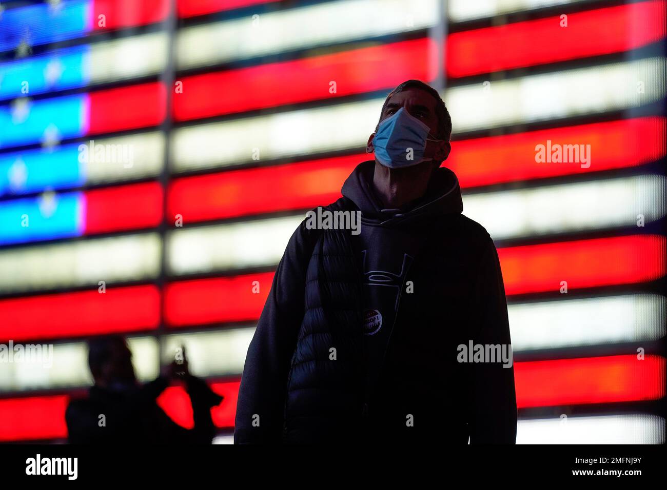 A man stops to watch election returns on electronic billboards in Times ...