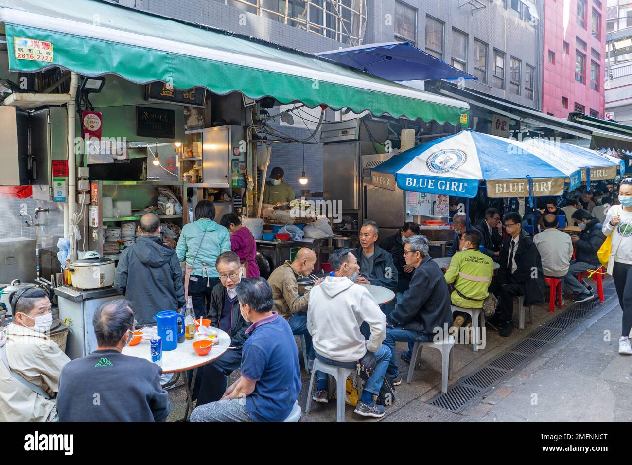 Hong Kong - December 2022 - People eating at open air food stall in ...