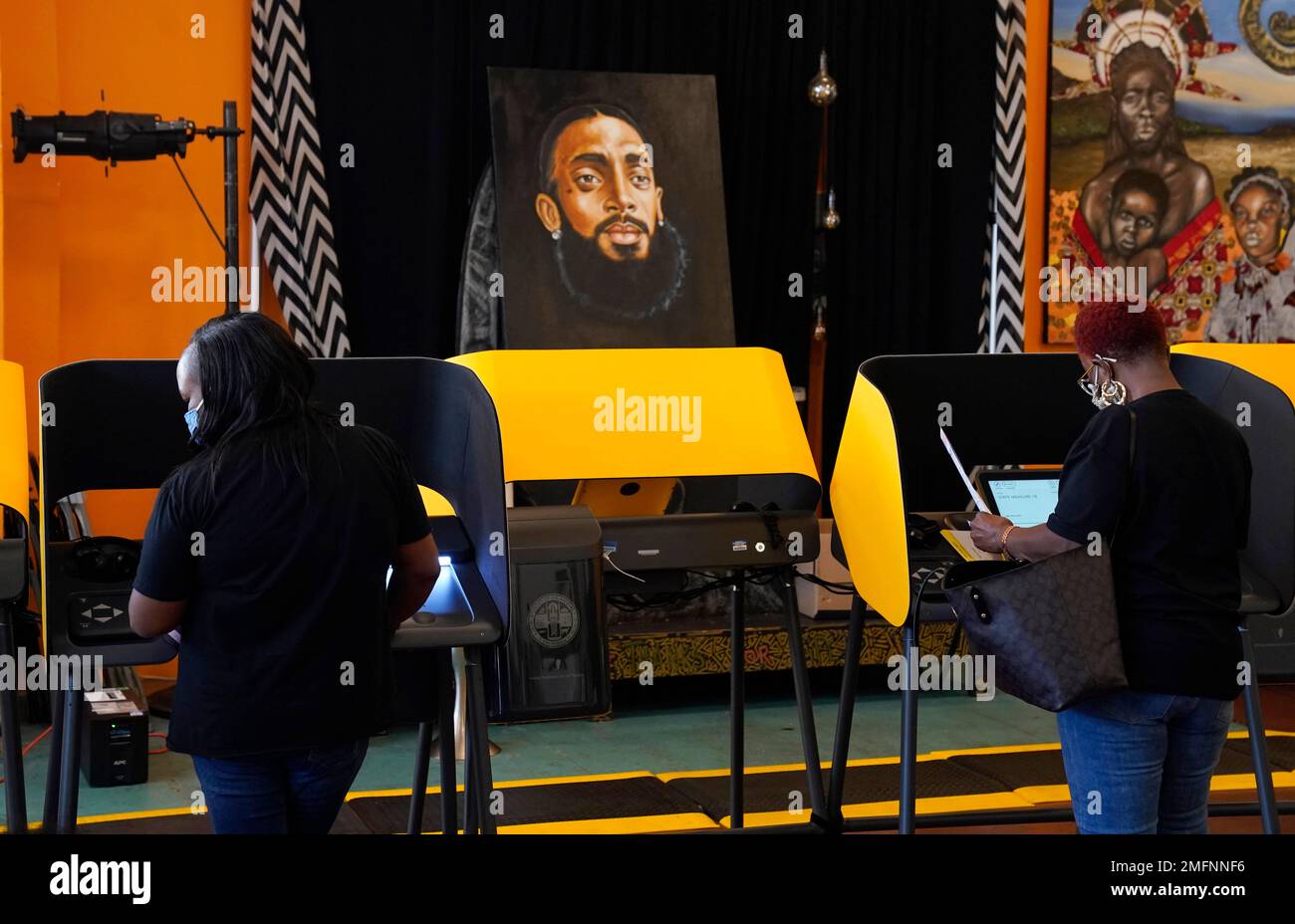 A portrait of the late rapper and entrepreneur Nipsey Hussle stands ...