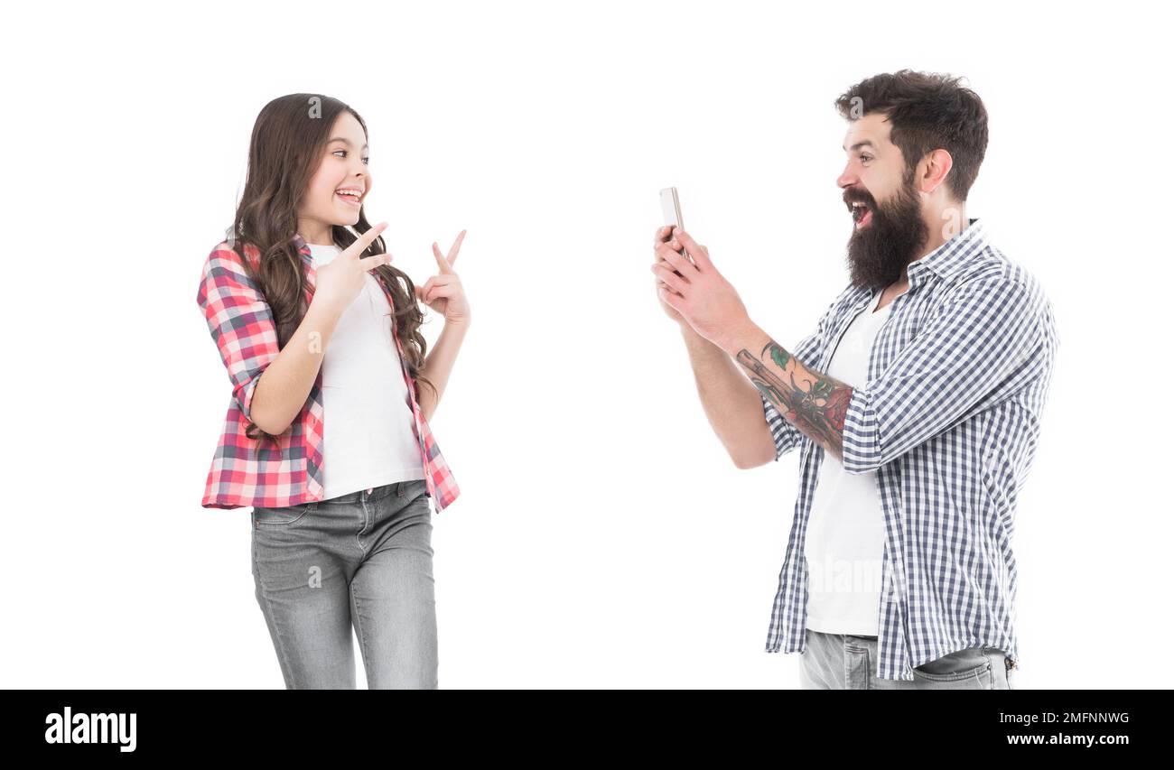 I love family. Happy daughter give peace signs to fathers cellphone ...