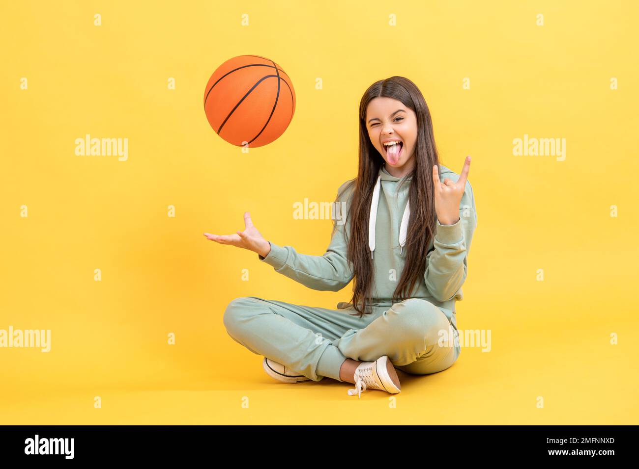 Girl sitting on basketball hi-res stock photography and images - Alamy