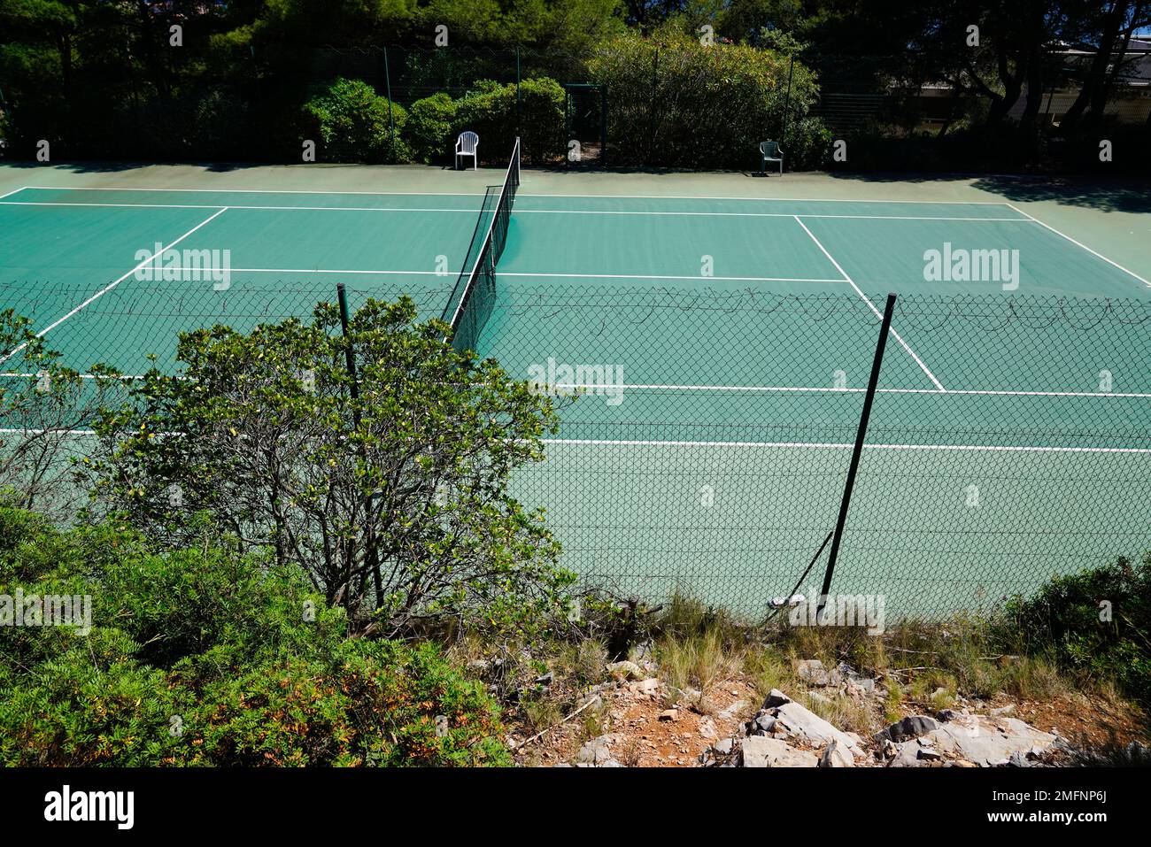 tennis court empty green with sport net in home private house garden ...
