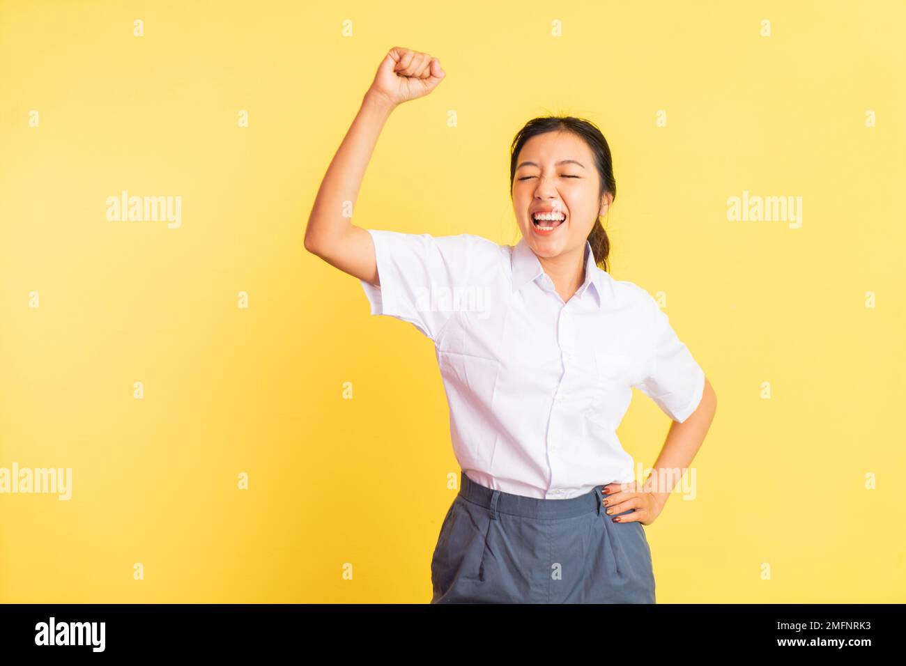excited teenage girl in high school uniform while celebrating something ...