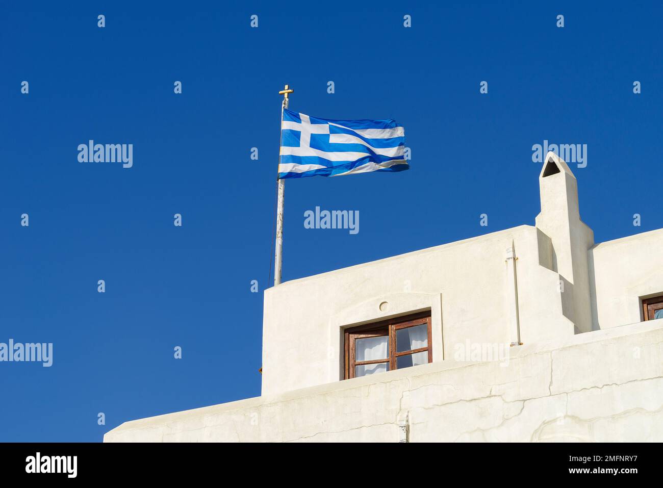 Greek flag on the building in a blue summer sky Stock Photo - Alamy