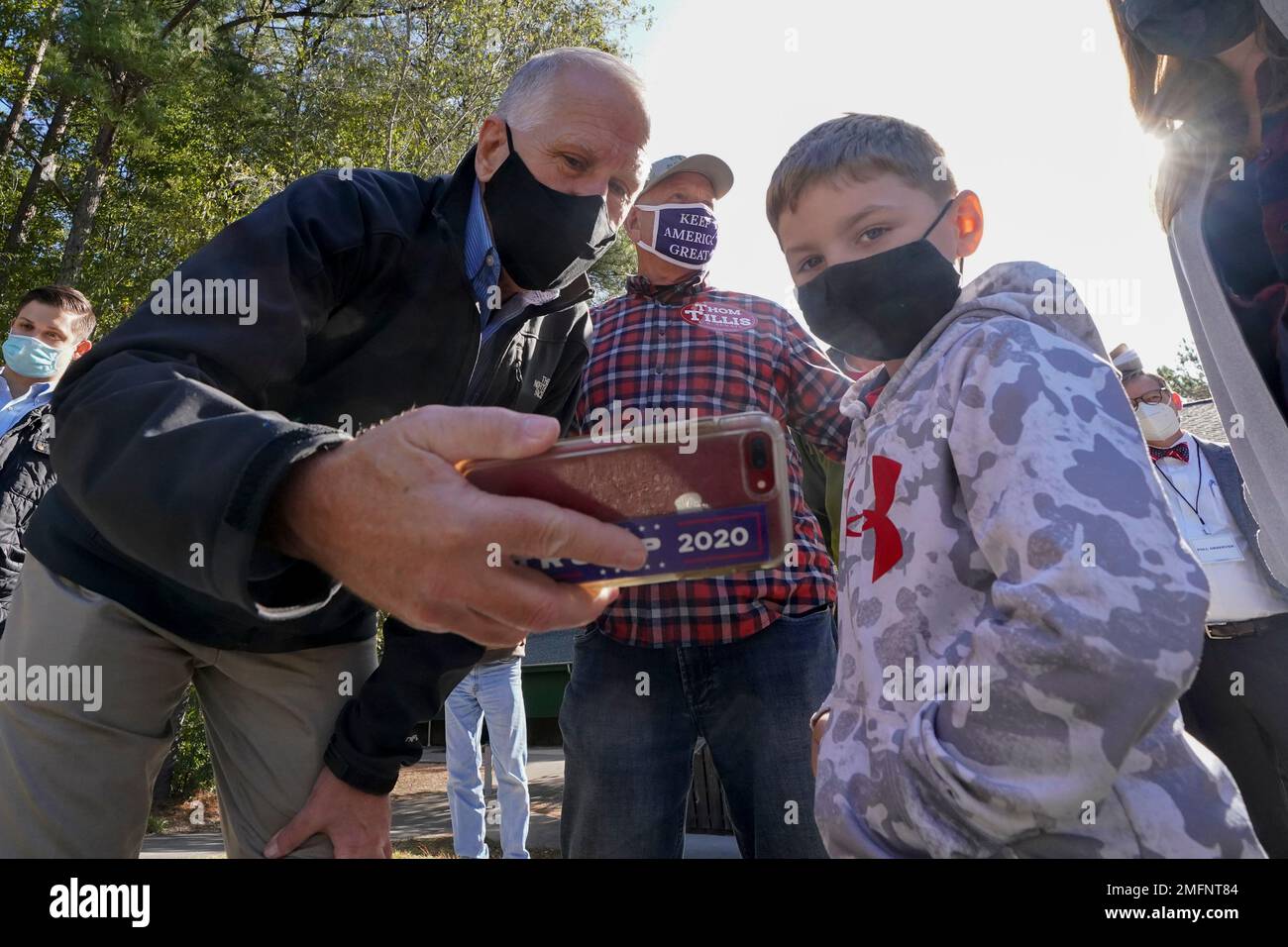 Sen. Thom Tillis, R-N.C., shows Sawyer McClure, 6, a picture during a ...