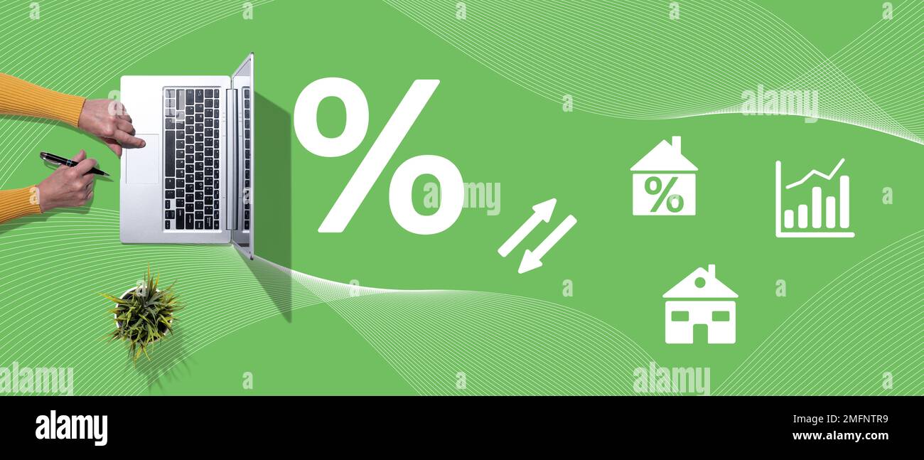 Top view of hands using laptop with symbol of interest rates concept ...