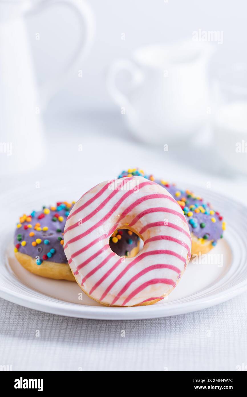 American donuts on white plate on bright background. Playful and ...
