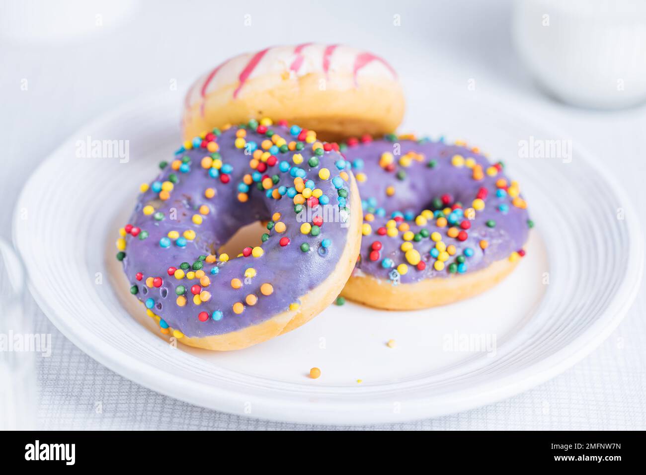 American donuts on white plate on bright background. Playful and ...