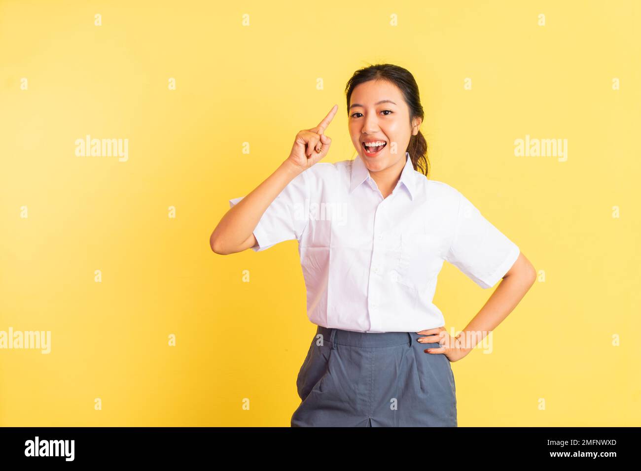 expression of teenage girl in school uniform getting an idea Stock ...