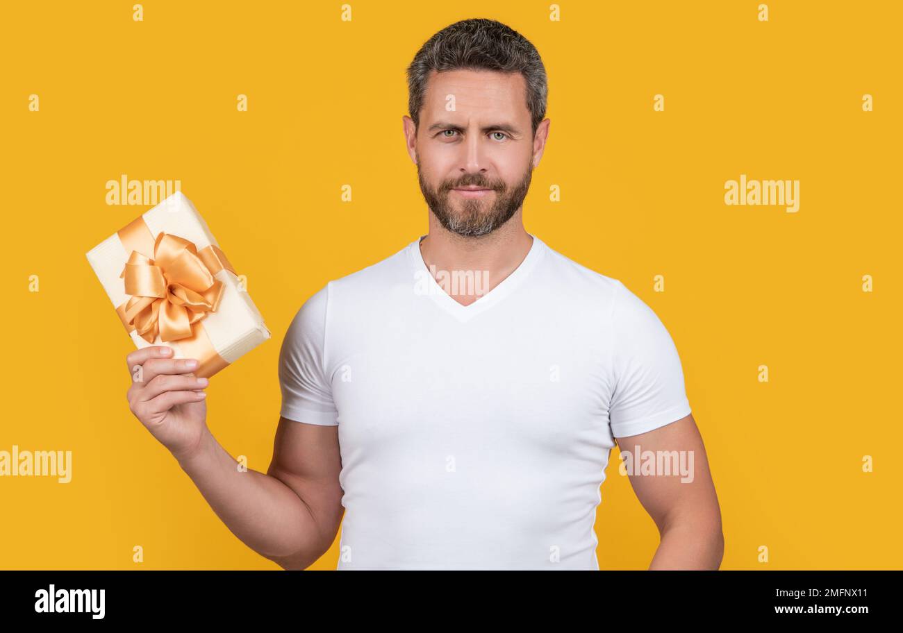 man hold present box in studio. man with present box for holiday. photo ...