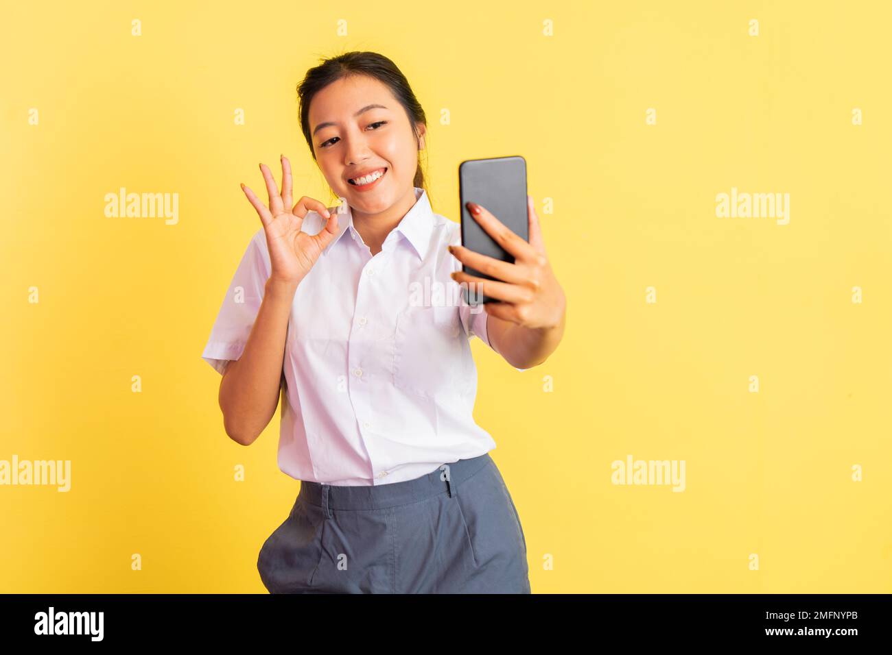 high school girl selfie using handphone with okay hand gesture Stock ...