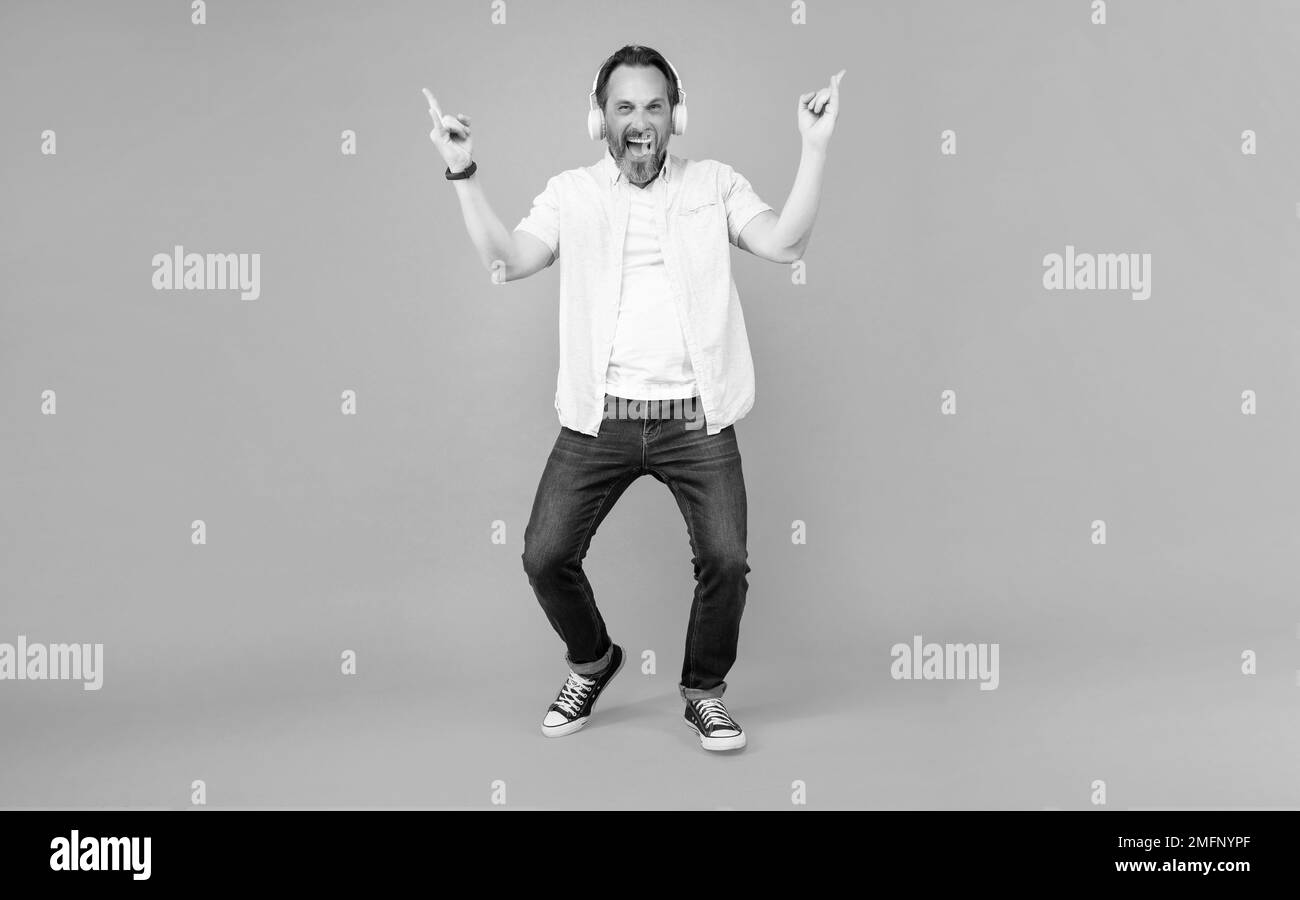 Happy old rocker sing along rock music playing in headphones making ...