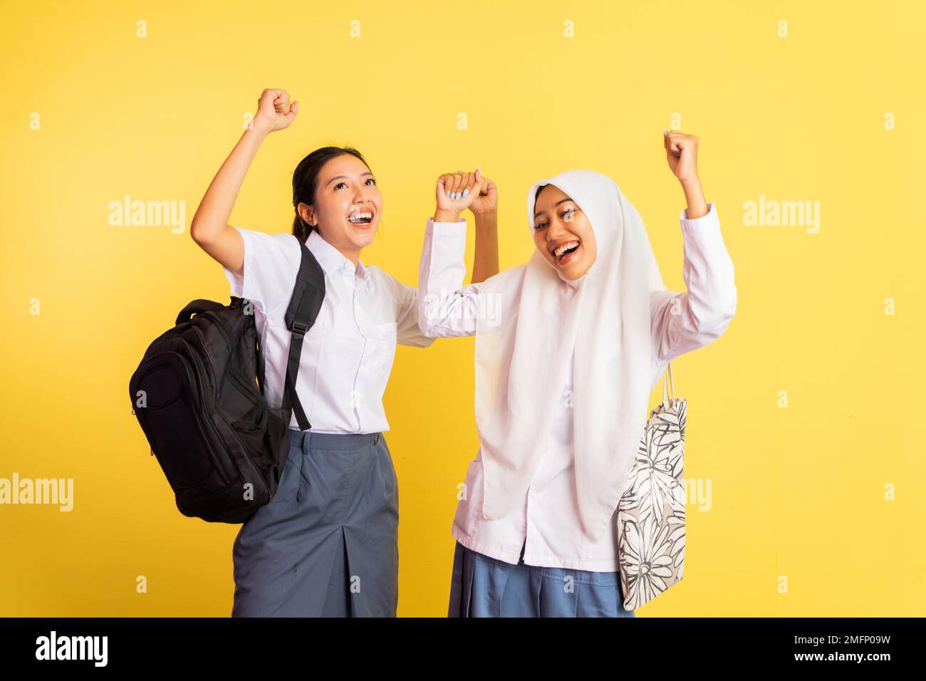 two excited high school girls in a pose celebrating graduation Stock ...