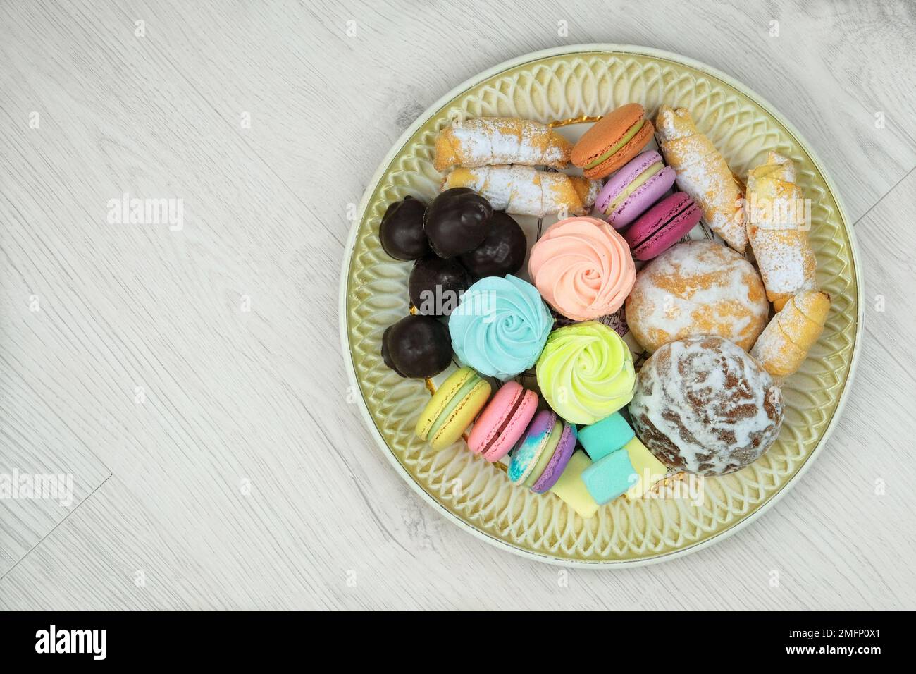 Sweet desserts in plate for the holiday on wood background ...