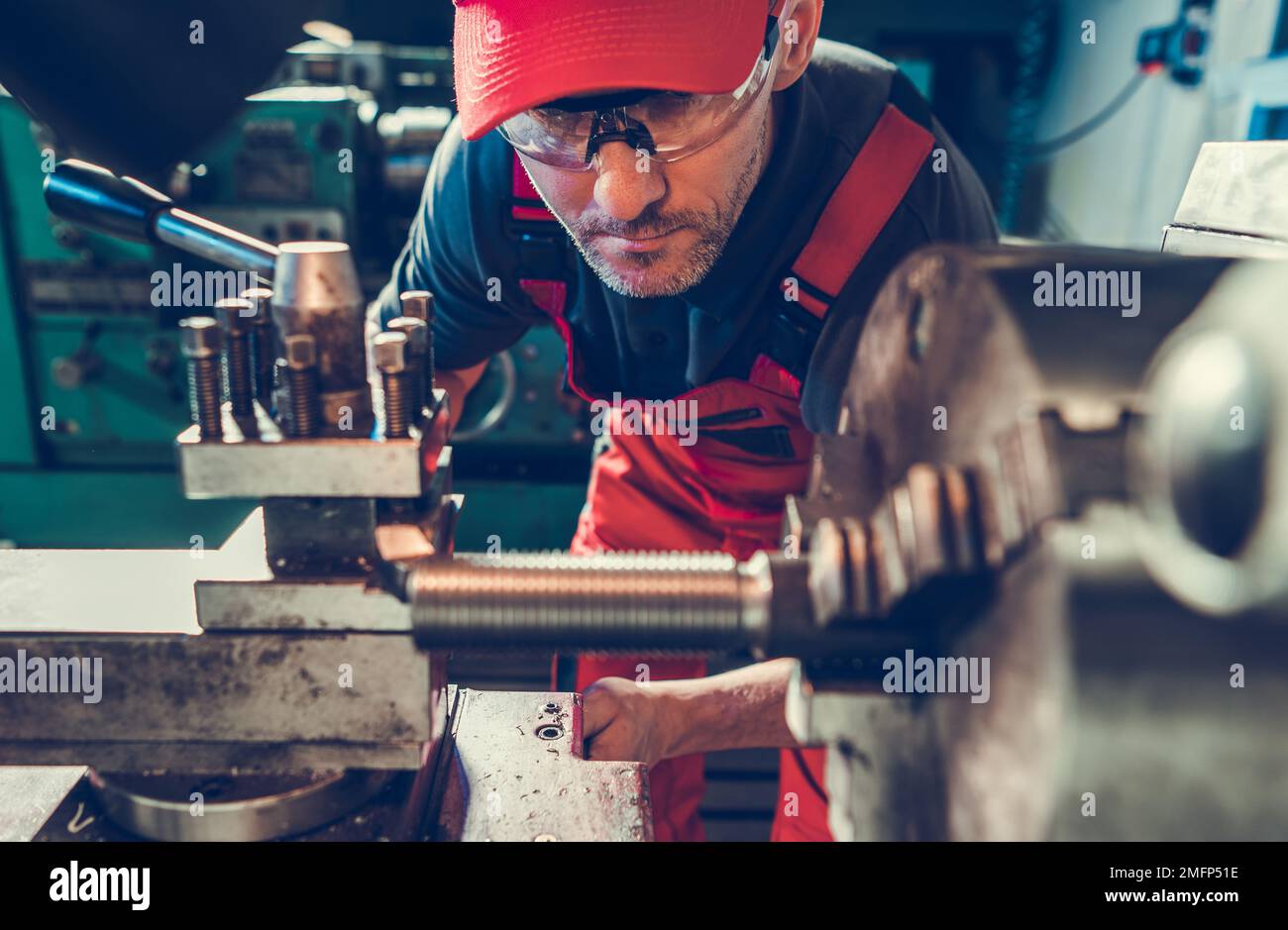 Caucasian Professional Lathe Machine Operator Wearing Safety Glasses Processing Piece of Metal ...