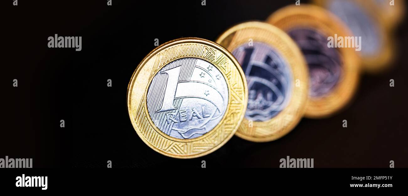images of one real coins, money from brazil on isolated black ...