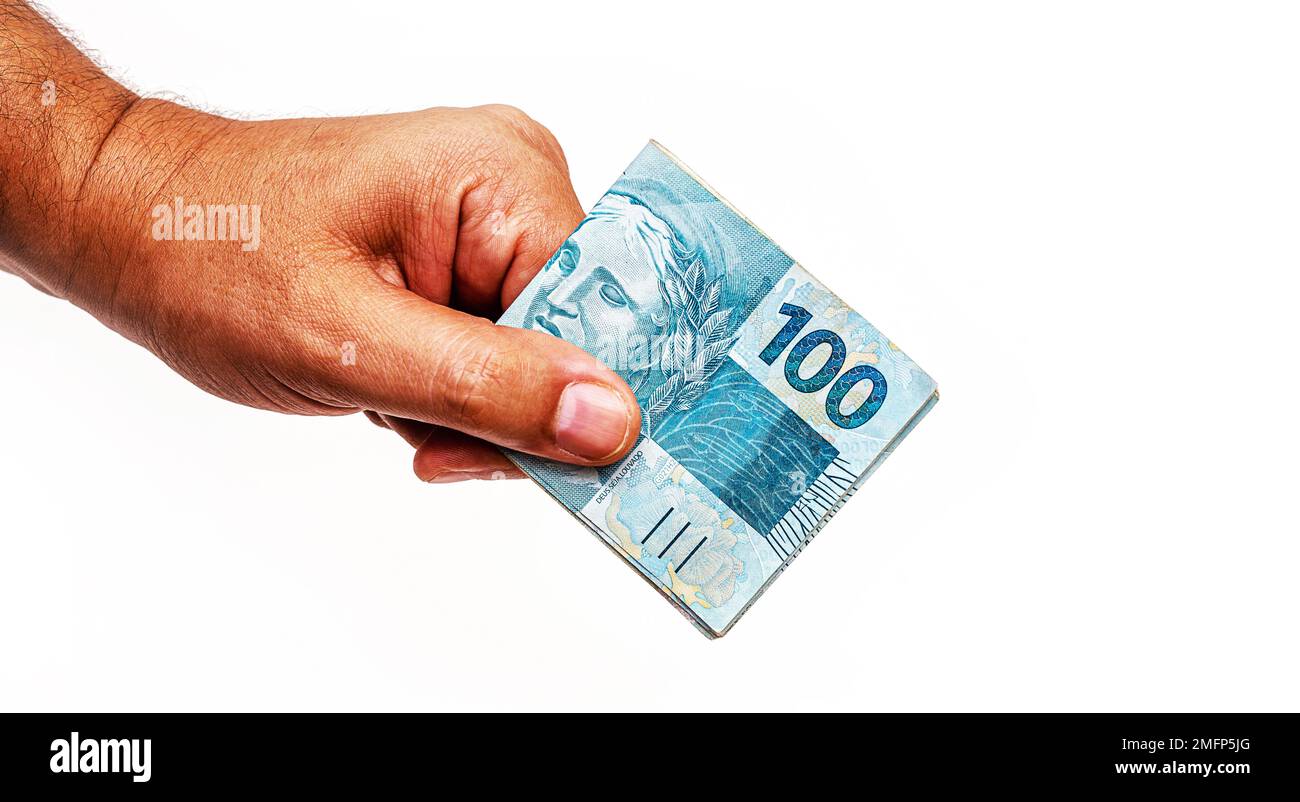 100 reais bills from Brazil, held by male hand on isolated white ...