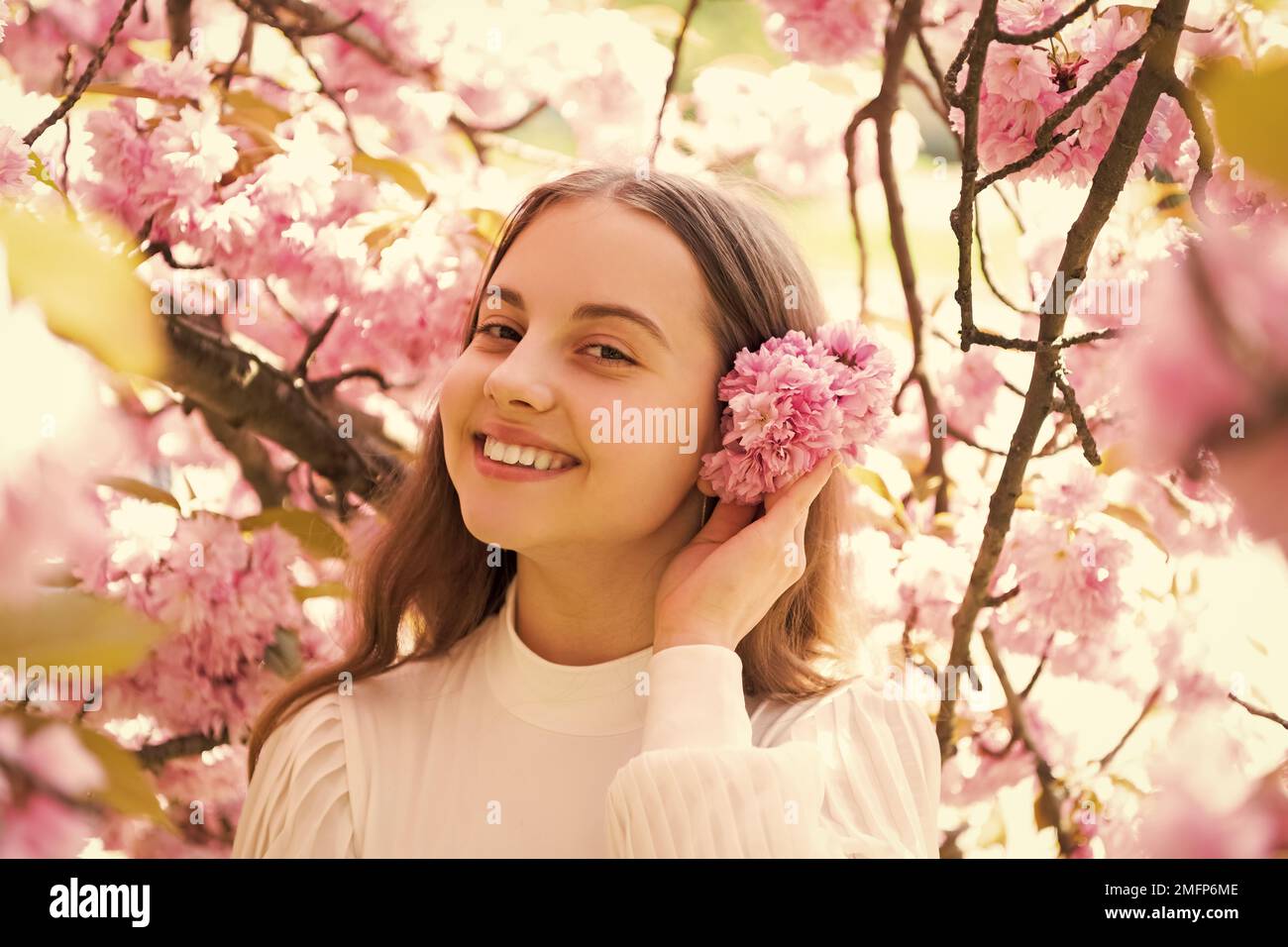 glad teen girl at sakura flower bloom in spring Stock Photo - Alamy