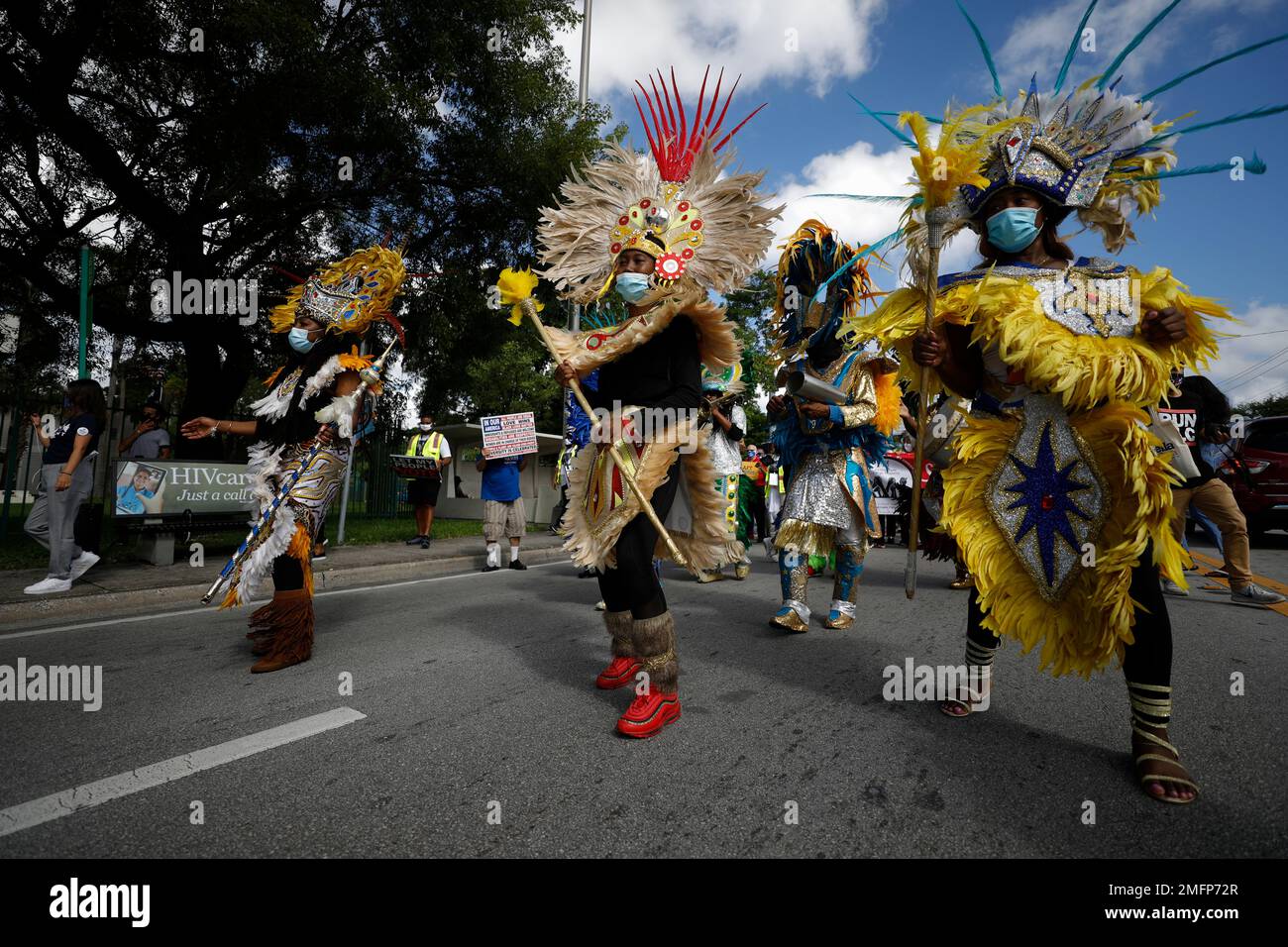 A Bahamian dance troupe leads a "Souls to the Polls" march toward an ...