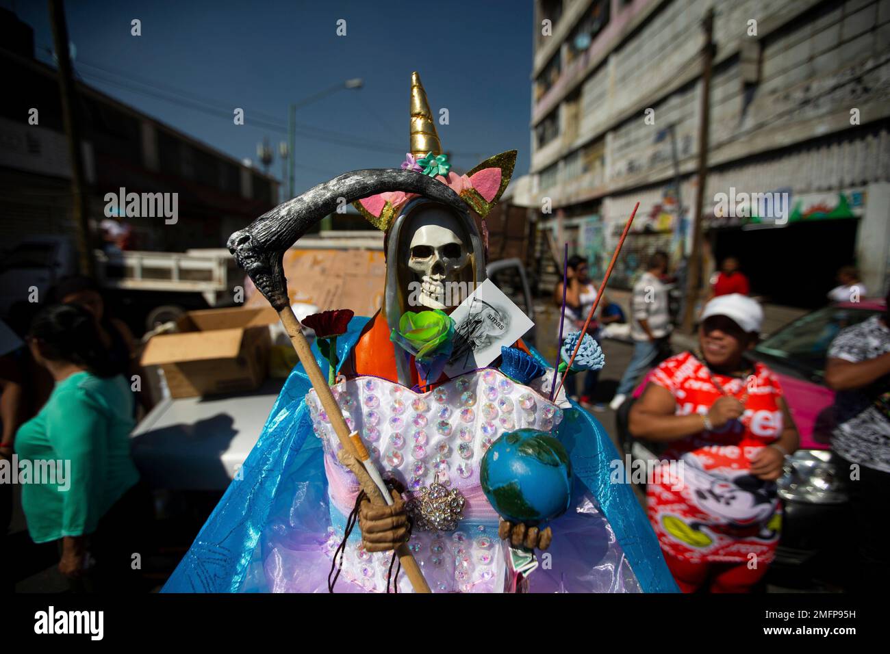 Devotees display an ornately decorated statue of the "Santa Muerte," or ...