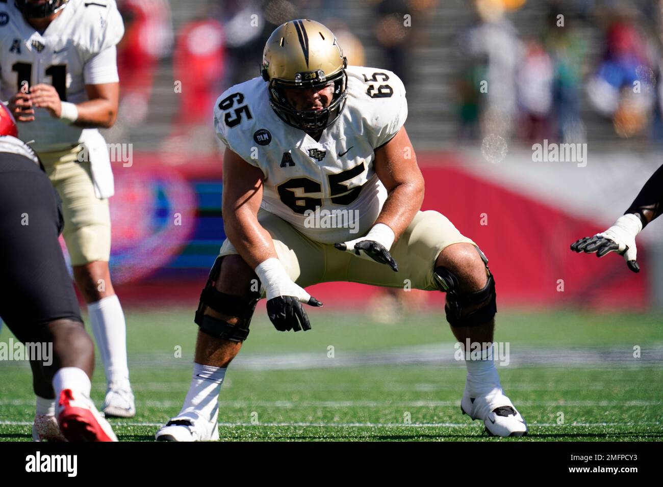 Central Florida offensive lineman Cole Schneider (65) looks to block ...