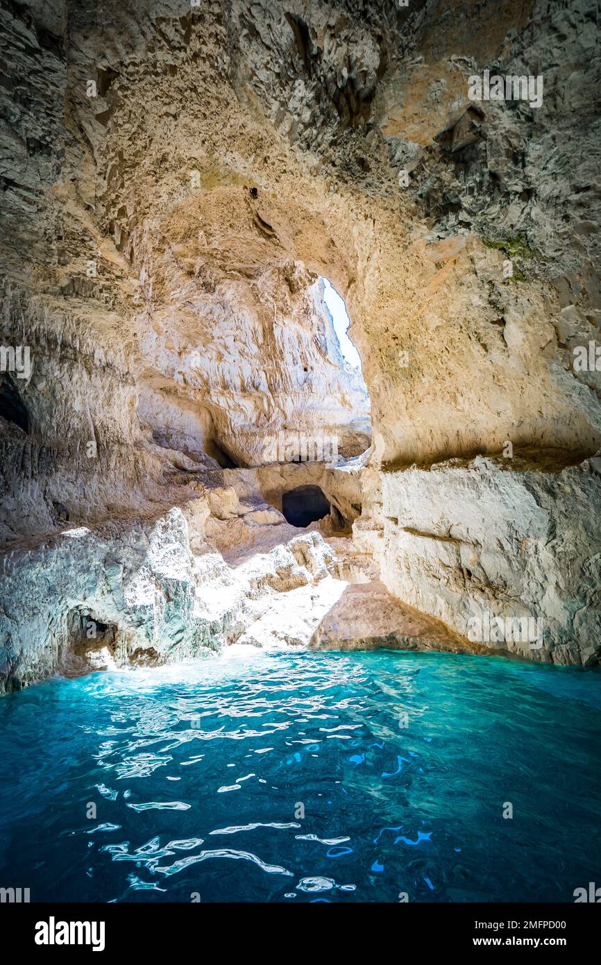 Close-up view of the inside of a sea grotto filled with tropical blue ...
