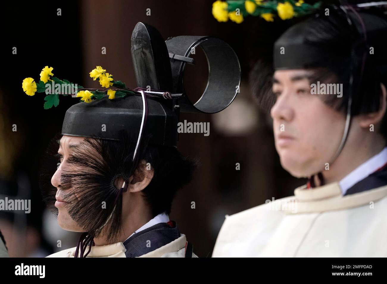 Artists in ritual clothing prepare to perform a ceremonial rite to mark ...