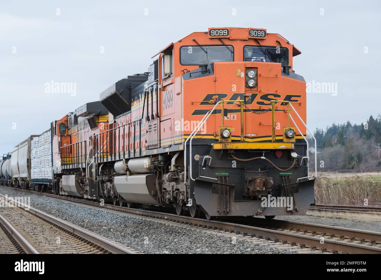 Stanwood, WA, USA - January 23, 2023; BNSF mixed freight train waits in branded paint scheme ...
