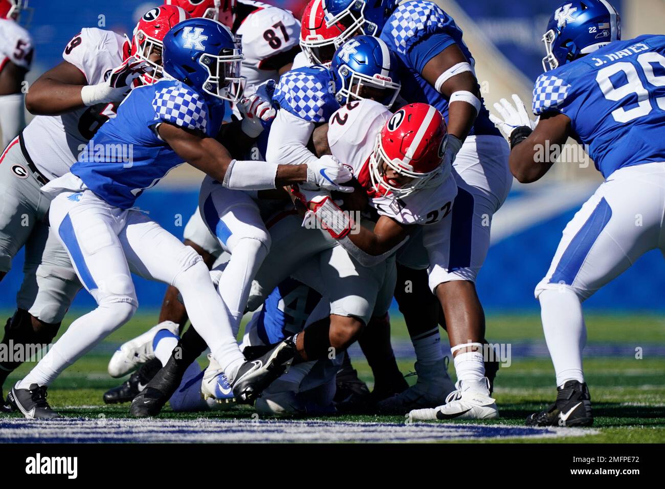 Georgia running back Kendall Milton (22) is tackled by several Kentucky ...
