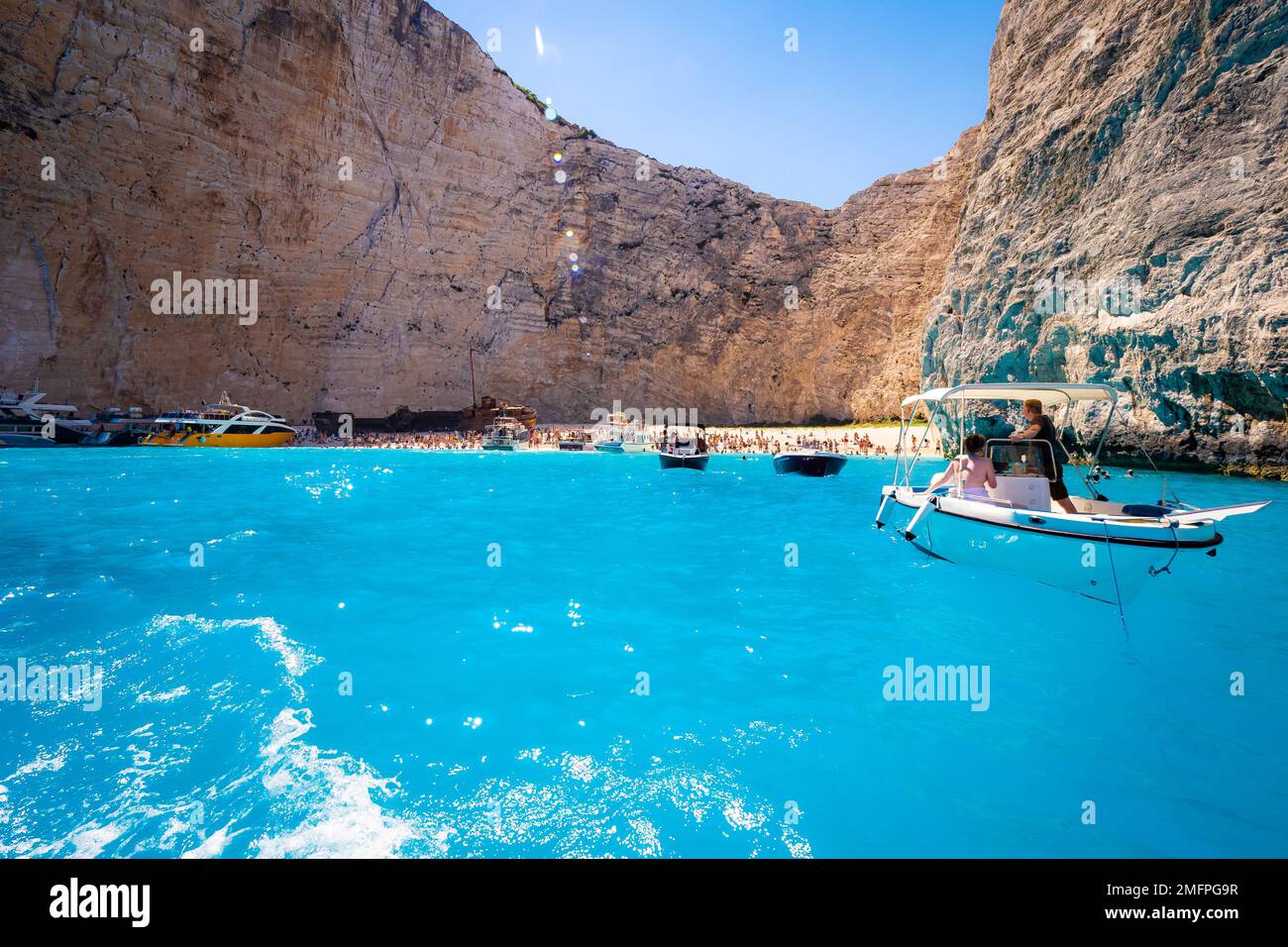 Beautiful view of boats taking tourists to the old rusty shipwreck ...