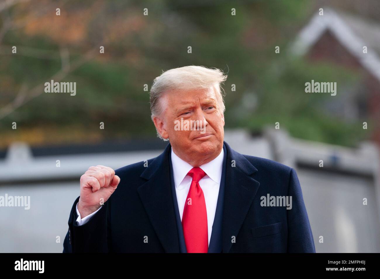 President Donald Trump pumps his fist as he arrives to speak at a ...