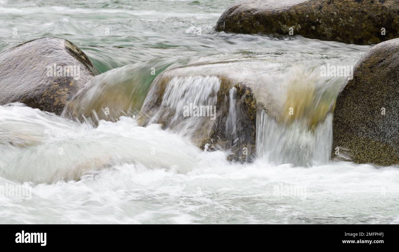 Water pouring over river rocks as the clean whitewater cascades in the ...