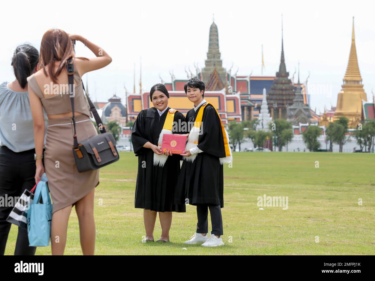 University students pose for photos ahead of their graduation ceremony ...