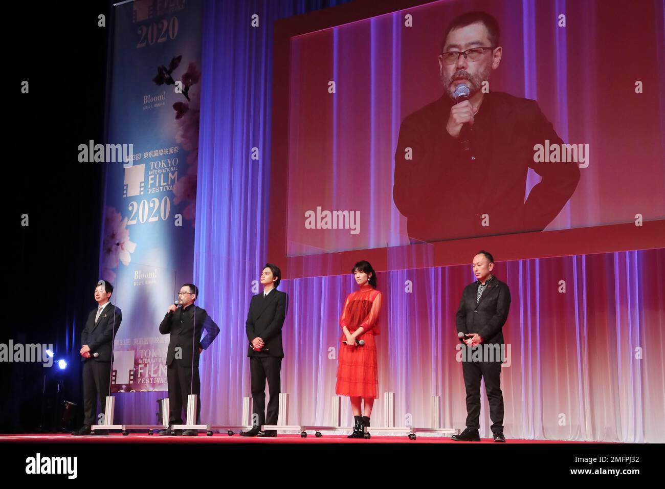 Director Masaharu Take, second from left, delivers a speech as producer ...