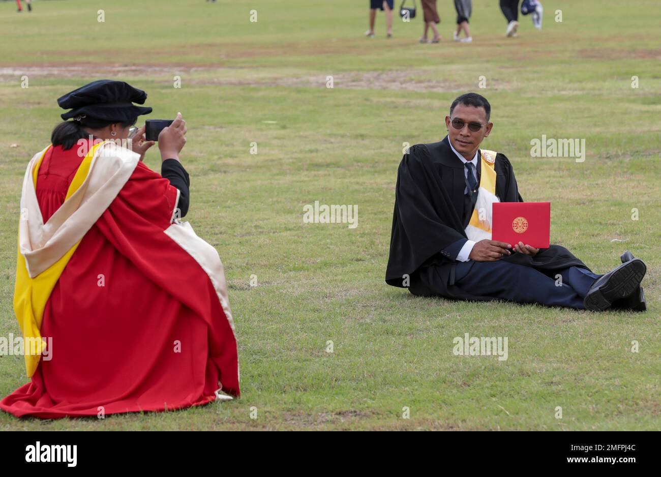 A university student poses for photos ahead of their graduation ...