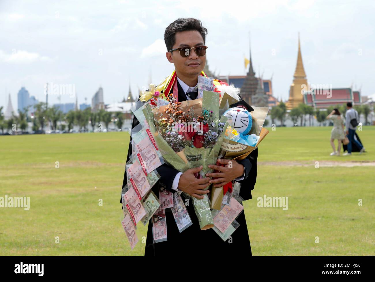 A university student poses for photos ahead of their graduation ...