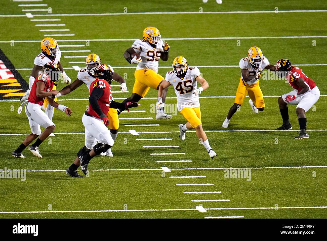 Minnesota defensive lineman DeAngelo Carter (99) runs with the ball ...