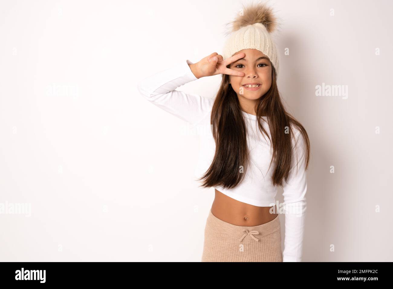 Pre Teenager child 9, 10, 11 years old showing fingers victory sign ...