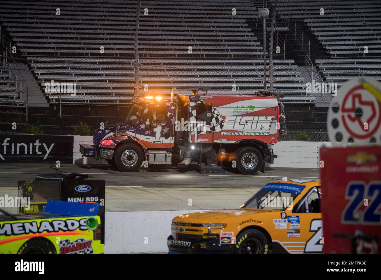 A sweeper cleans the track before the NASCAR Truck Series auto race at ...