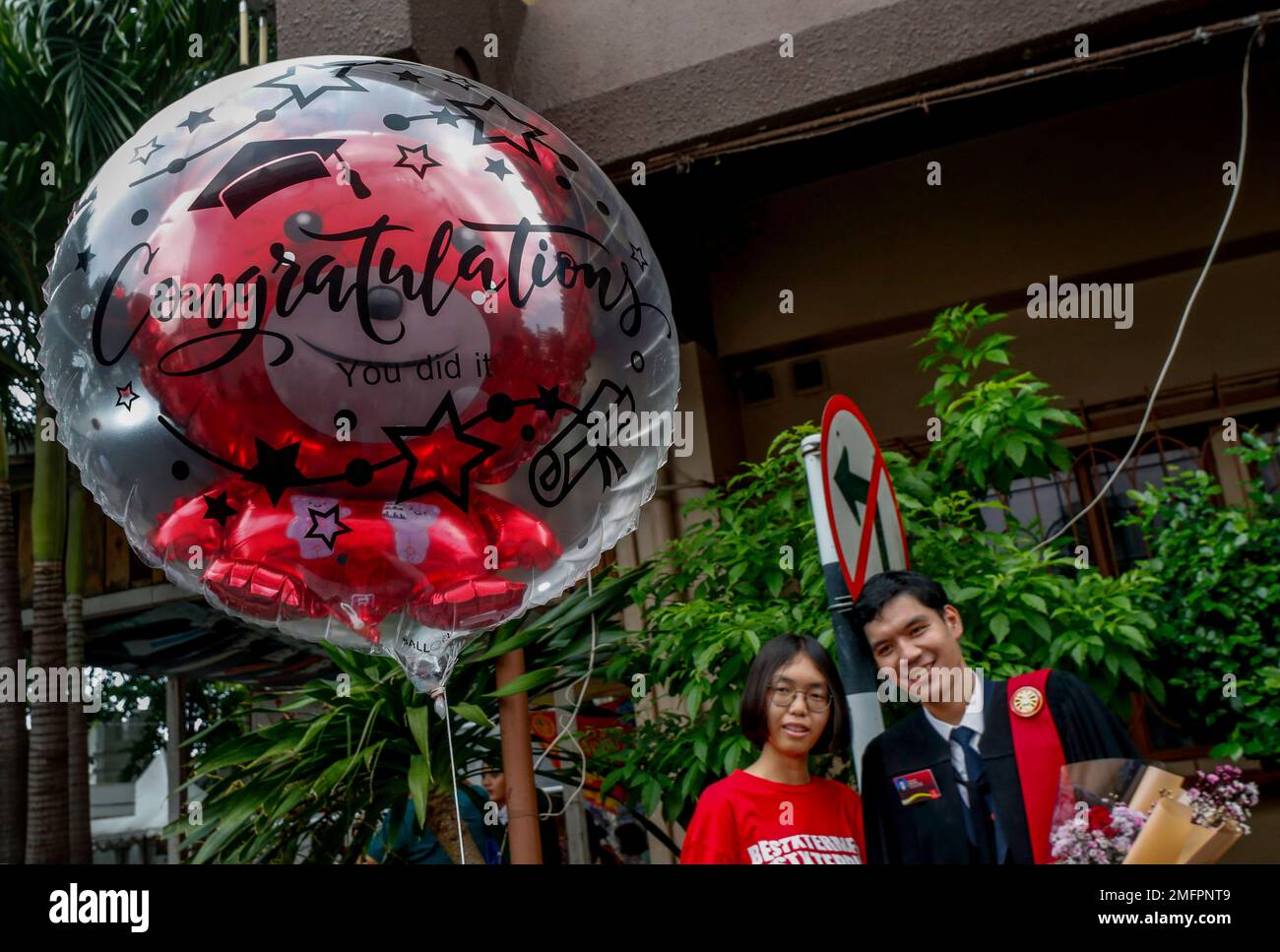 A university student poses for a photo ahead of his graduation ceremony ...