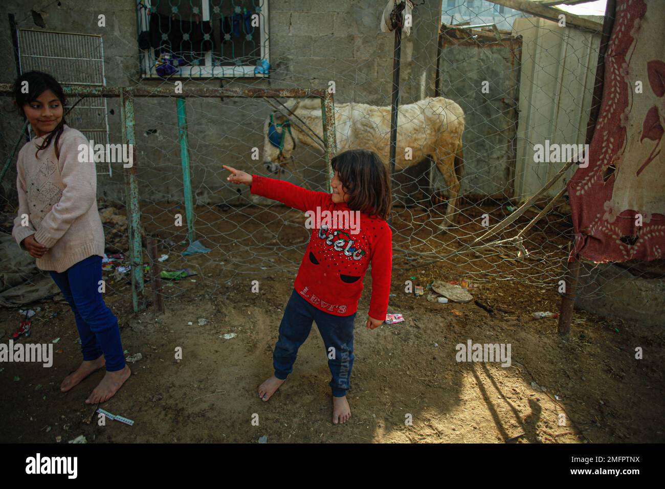 Palestinian children play outside their homes in a poor neighborhood in ...