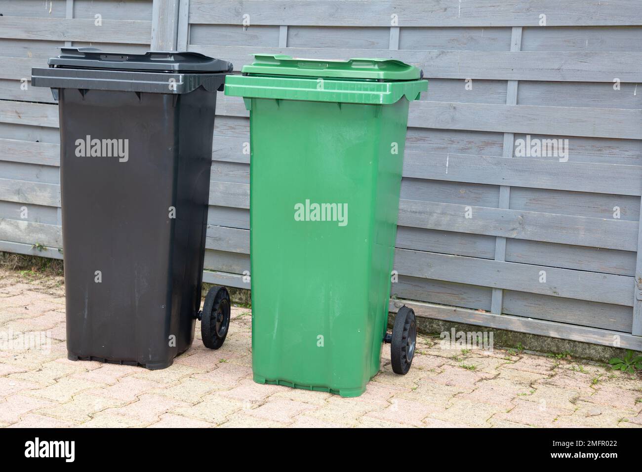 black and green plastic garbage bin in street for recycling concepts ...