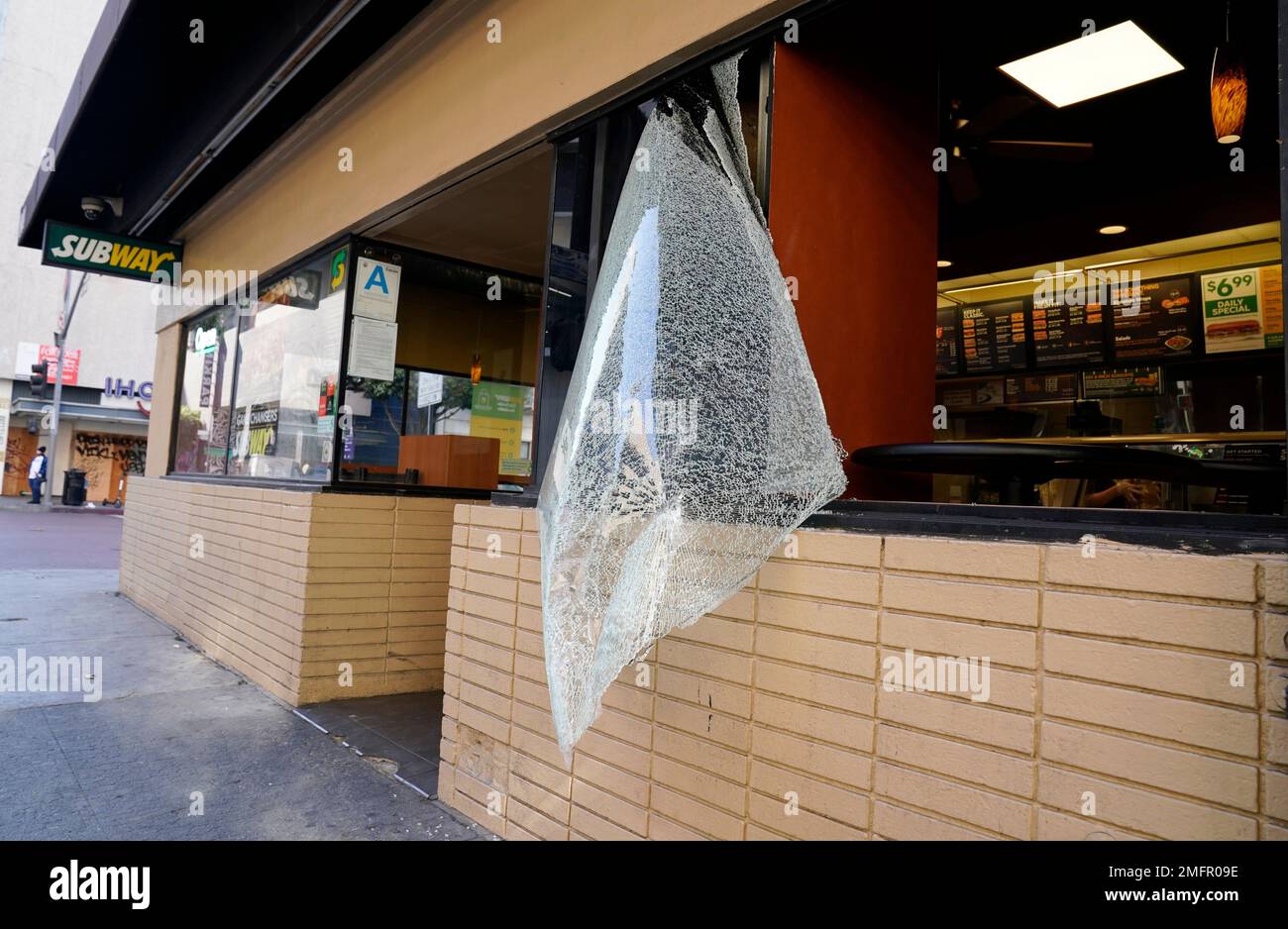 A smashed window is pictured at a Subway sandwich store that was ...