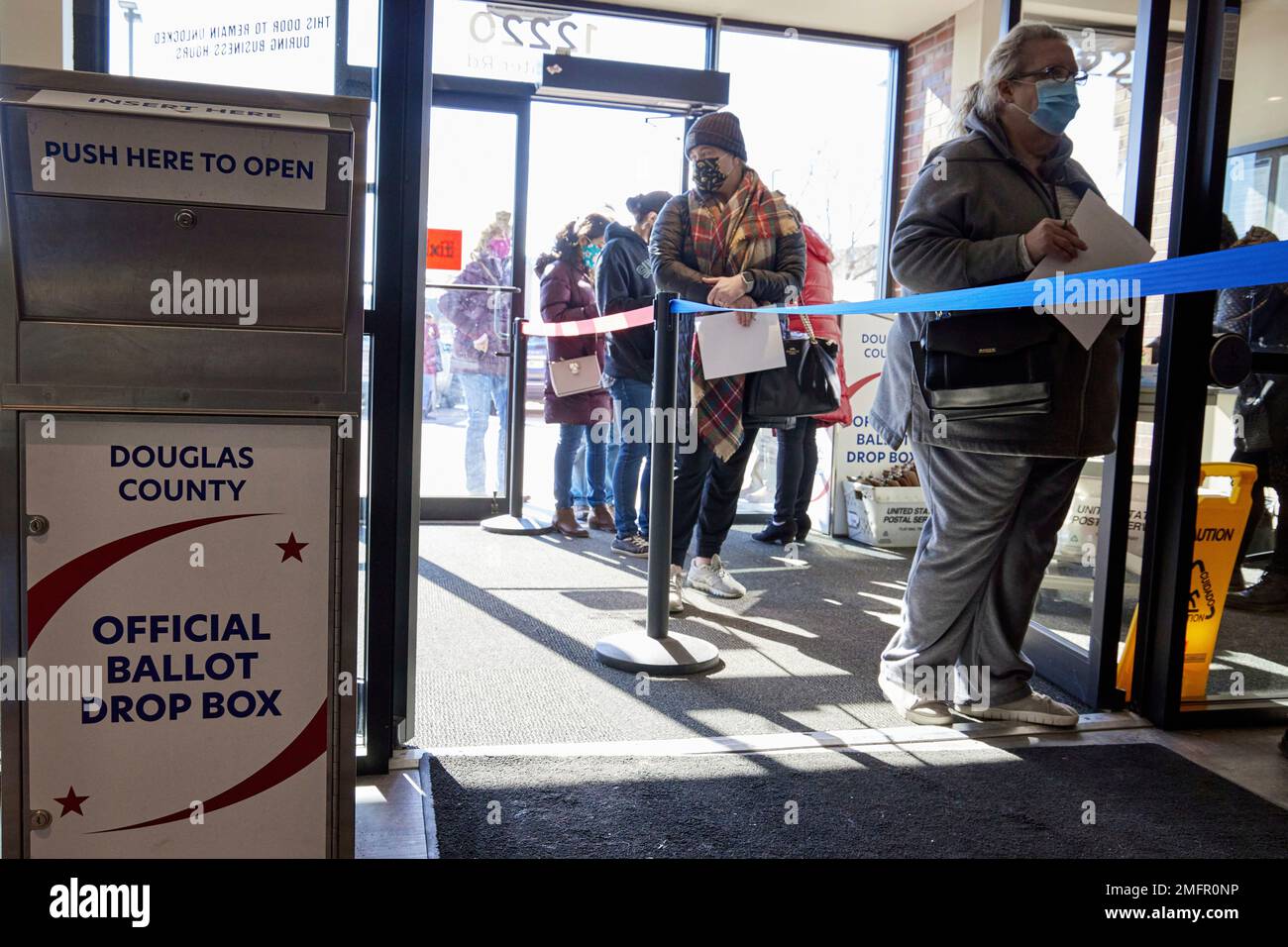 Residents stand in line to vote early at the Douglas County Election ...